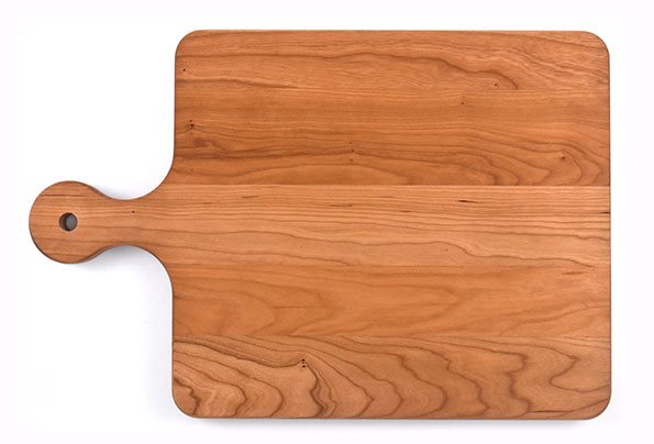 Cutting board with rounded handle